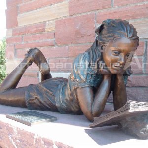 Girl Reading Book Statue Lying on a Bench sculpture