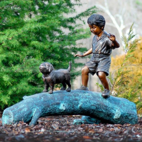 boy and dog on log statue
